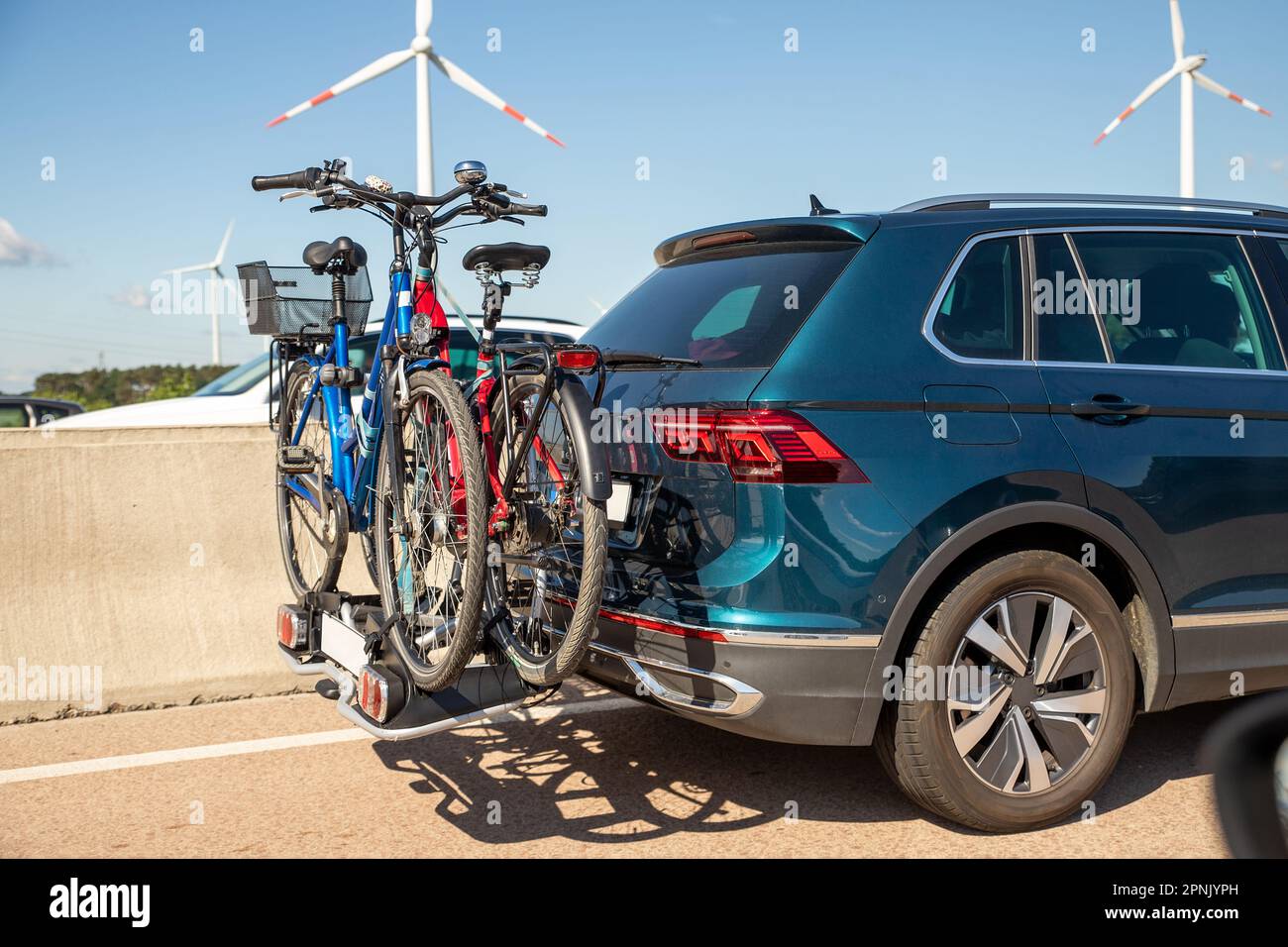 Back view modern white family wagon car with mounted roof box trunk and ...