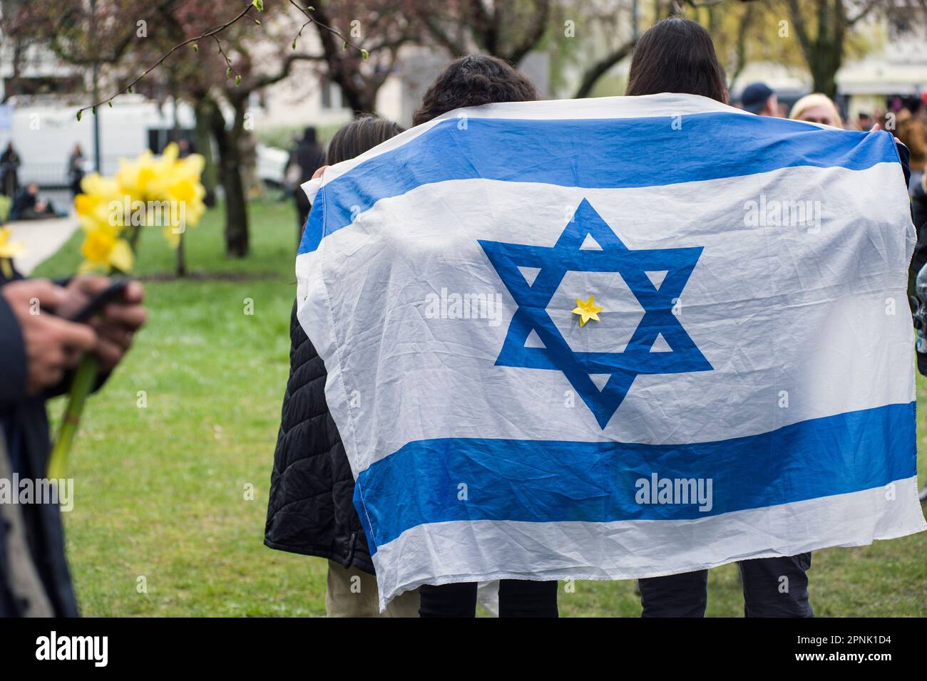 Israeli students are seen holding Israeli flags during the ceremony ...