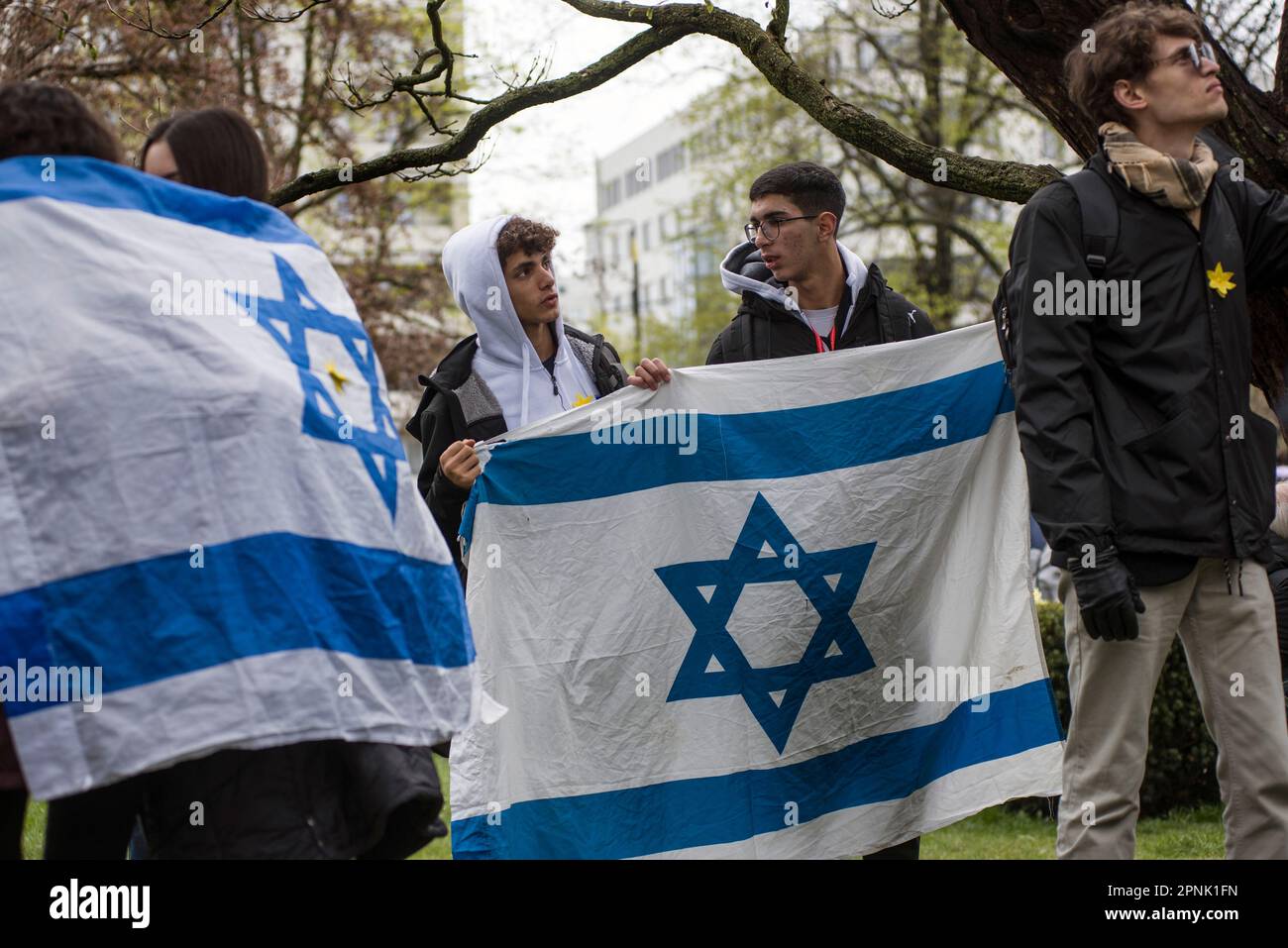 Israeli students are seen holding Israeli flags during the ceremony ...