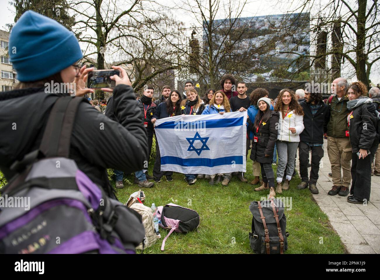 Israeli students are seen taking pictures while holding Israel's flag ...