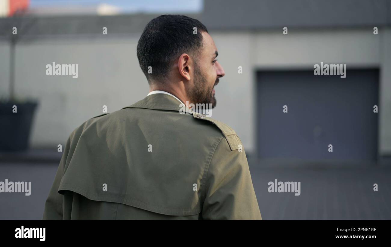 One happy Arab man walking outside in city street during sunset. A ...