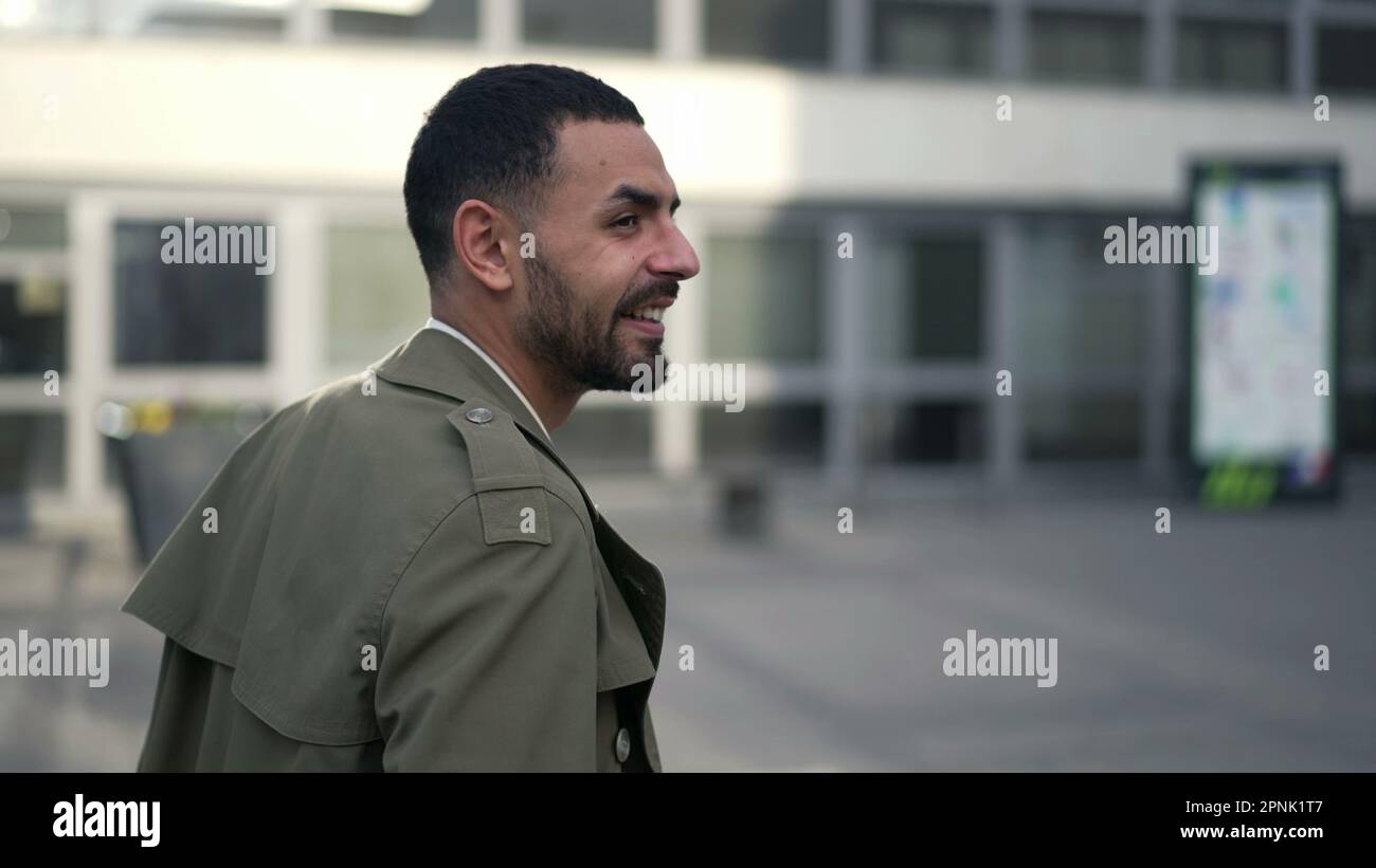 One happy Arab man walking outside in city street during sunset. A ...