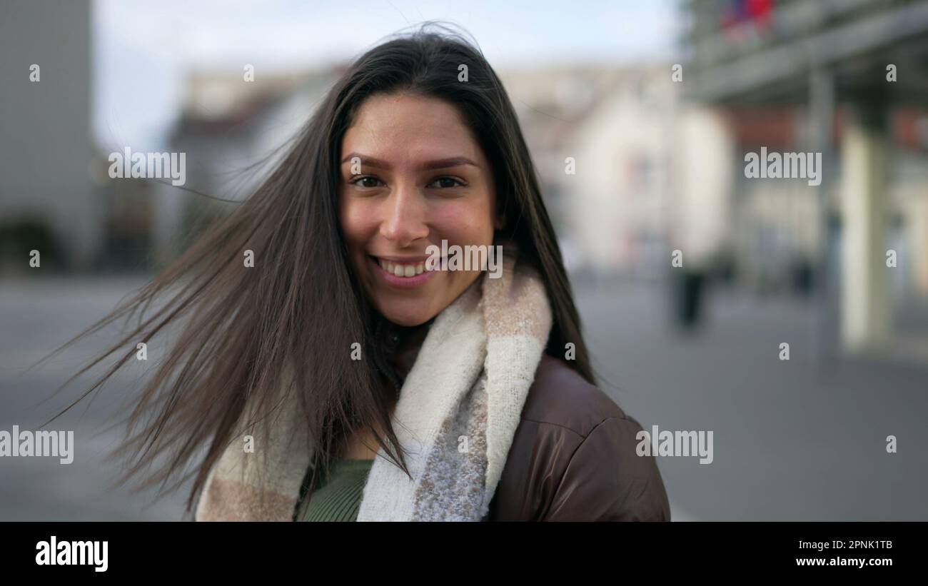 One happy carefree young woman turning head to camera smiling. Portrait ...