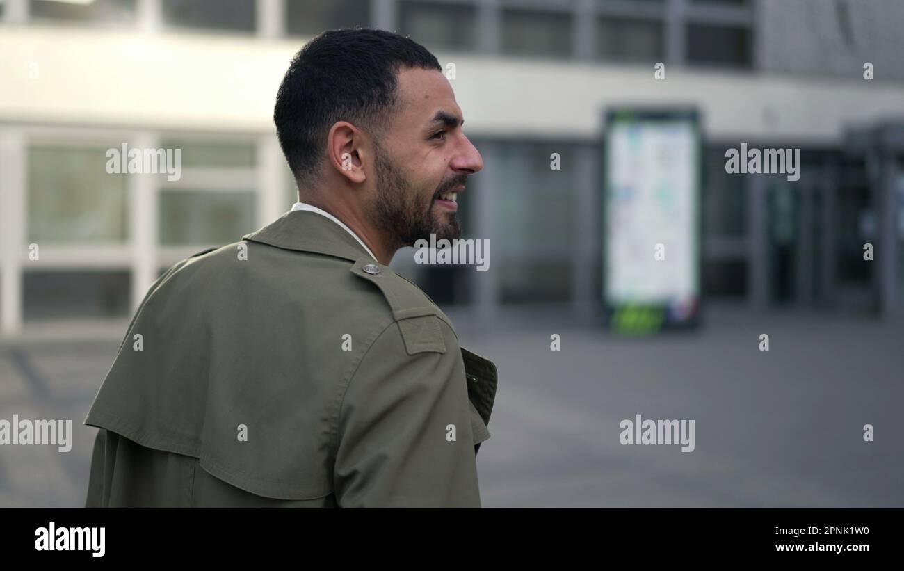One happy Arab man walking outside in city street during sunset. A ...