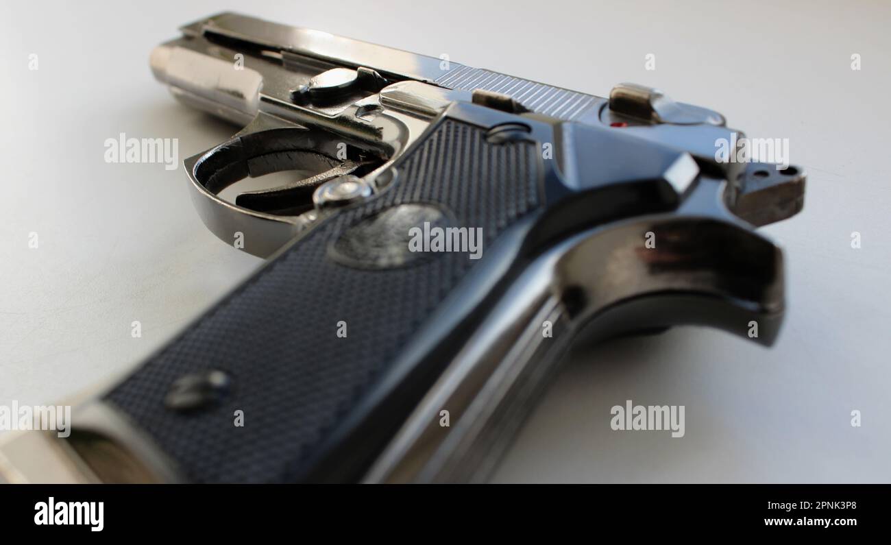 The back side of the grooved pistol grip with the hammer not cocked ...