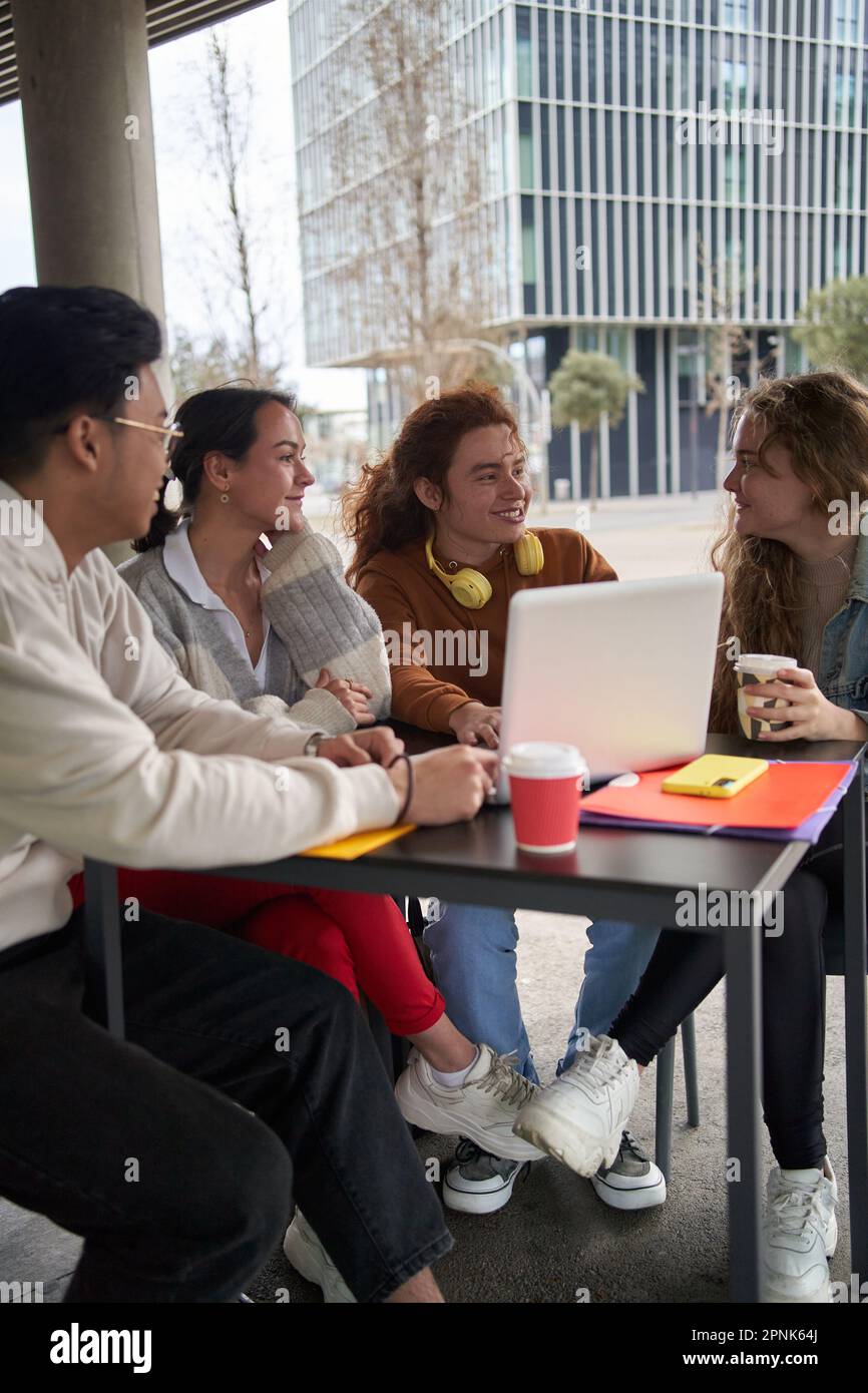 Vertical focused group young multiracial people using computer sitting ...