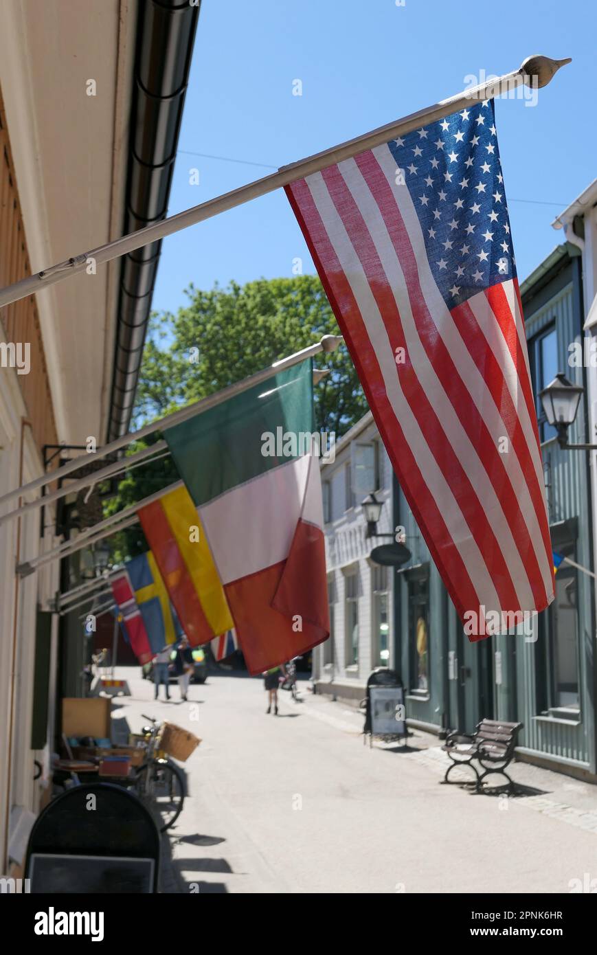 Low angle view of flags of different countries on street in city Stock ...