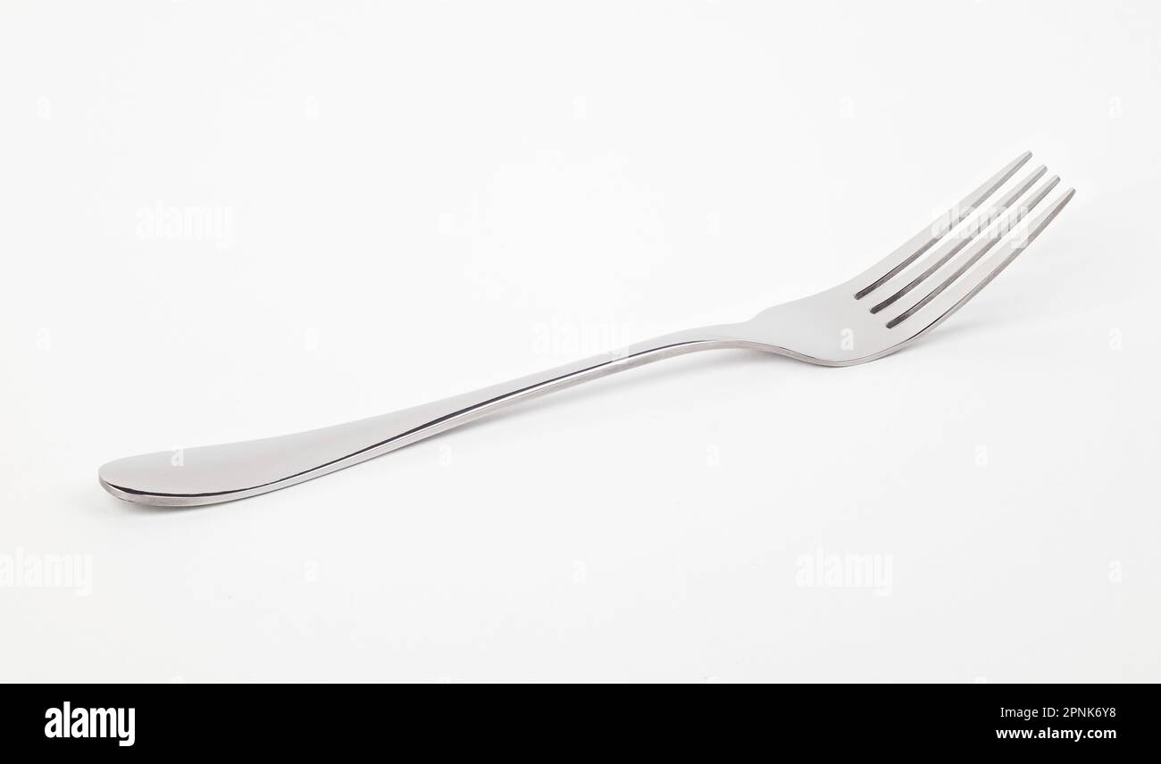 Metal fork lying on a white background. Front view Stock Photo - Alamy