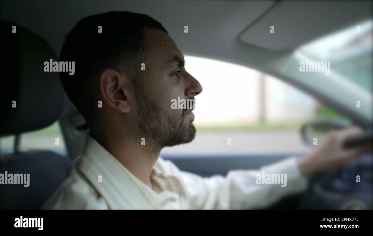 Profile closeup face of one Arab man driving car. Interior shot of a ...