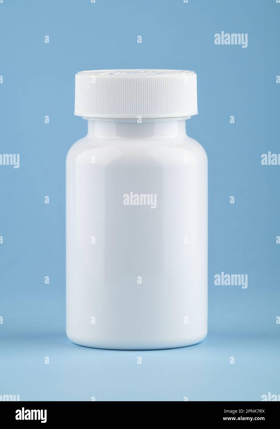 White medical container of pills on light blue background. Drugs and ...