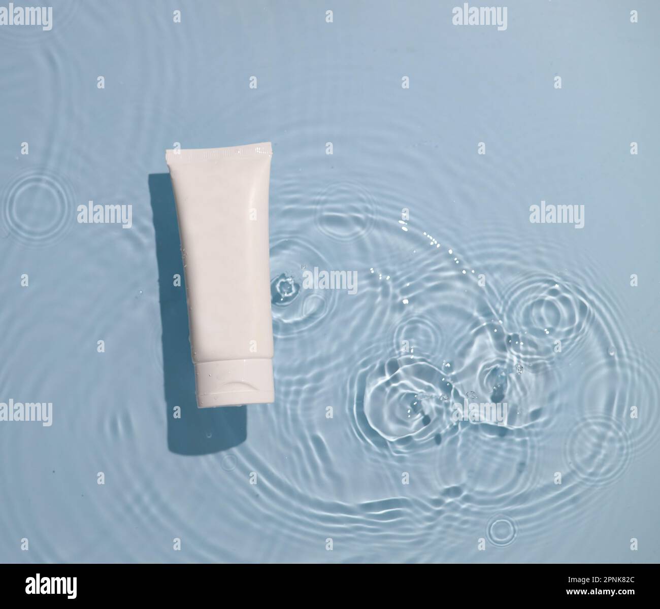 A white toothpaste tube isolated on a light pastel background Stock ...