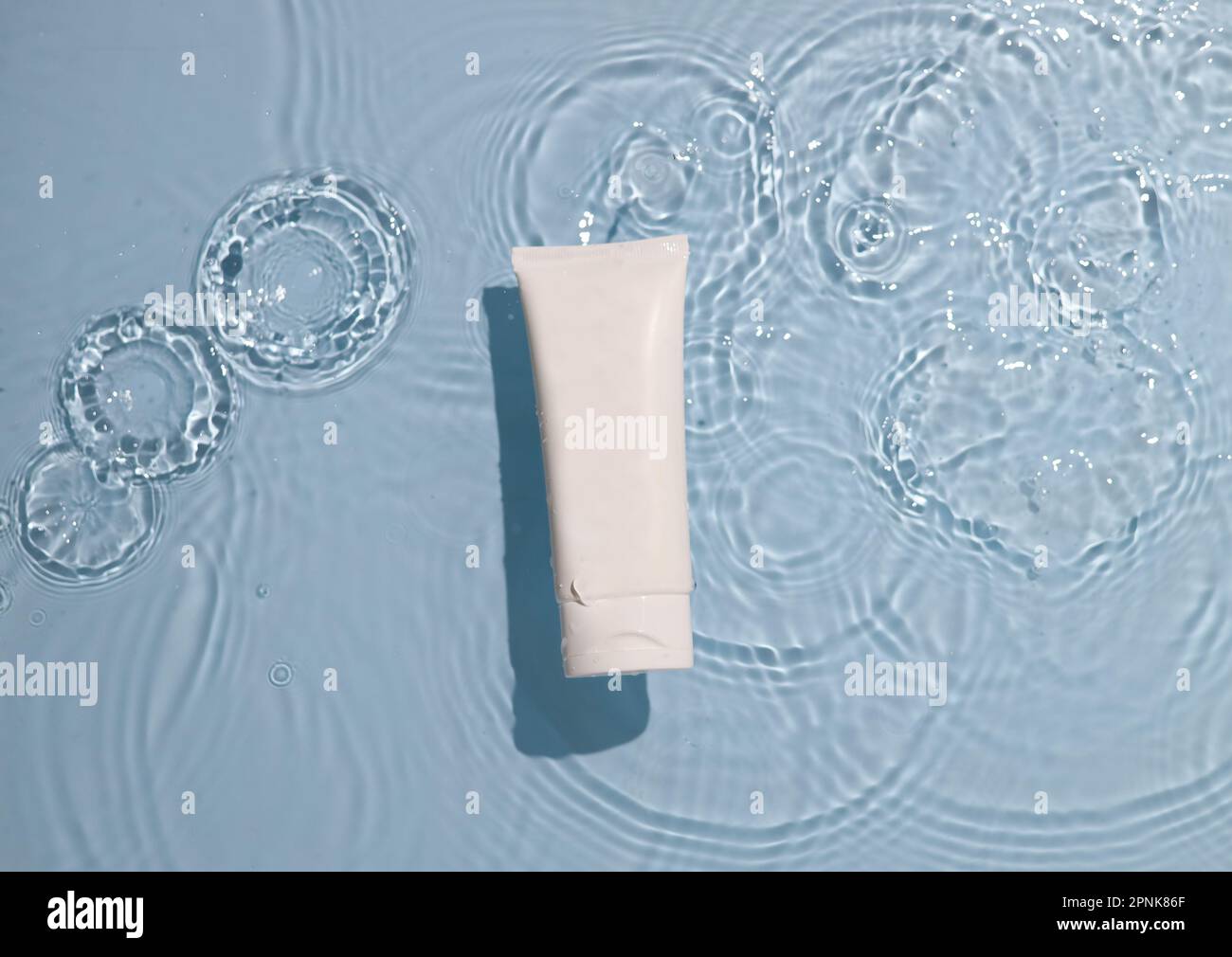 A white toothpaste tube isolated on a light pastel background Stock ...