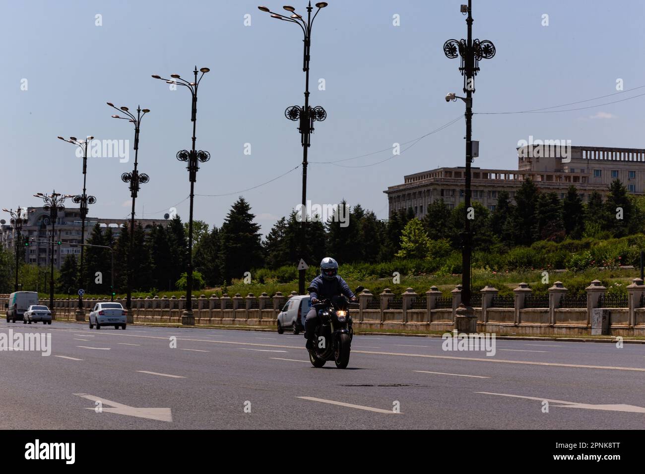 Biker on a motorcycle in traffic at rush hour in downtown area of the ...