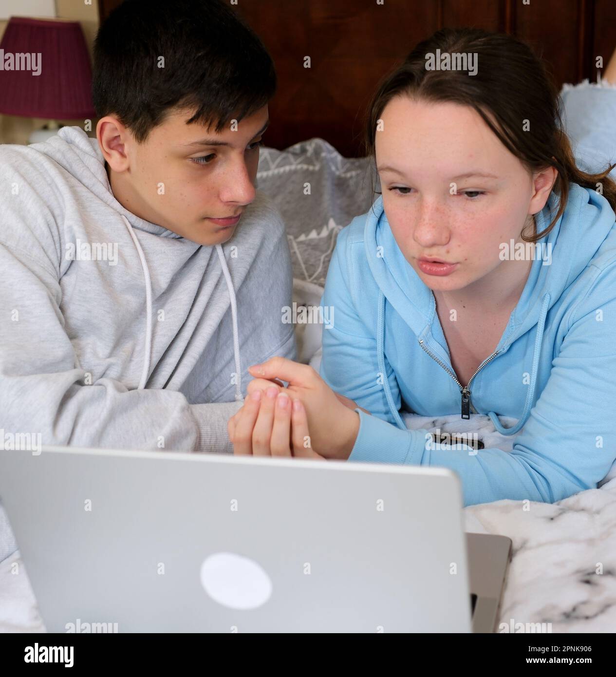 online learning teenagers boy and girl sitting near laptop and doing ...