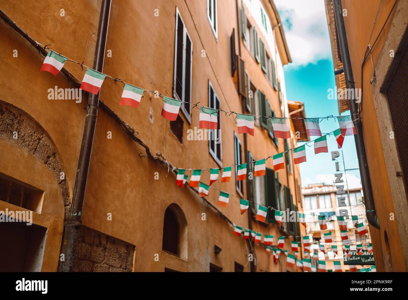 Holiday in the Italian city of streets with Italian flags and ancient ...