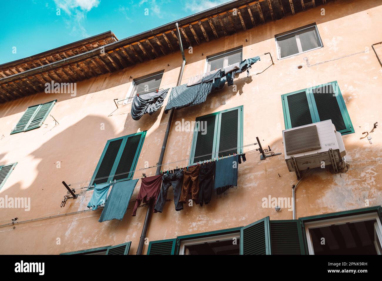 Traditional way of drying laundry in old facade build, Pisa, Italy ...