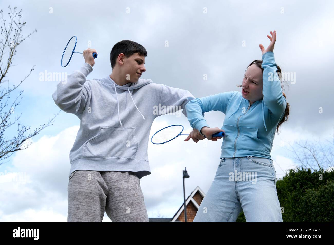badminton rackets boys girl swing each other with racket background of ...