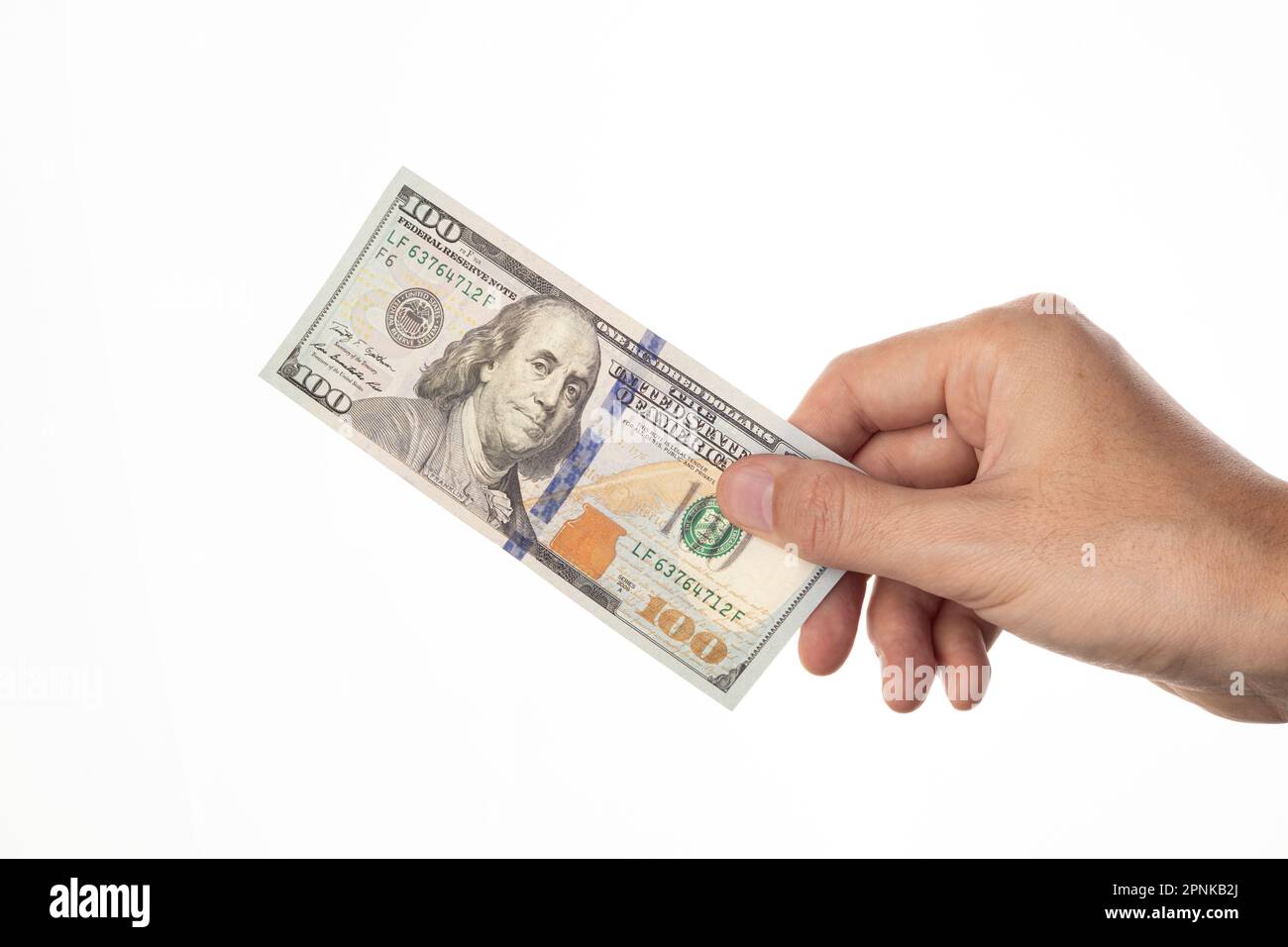 Man hand giving 100 dollar bills isolated on white background. One ...