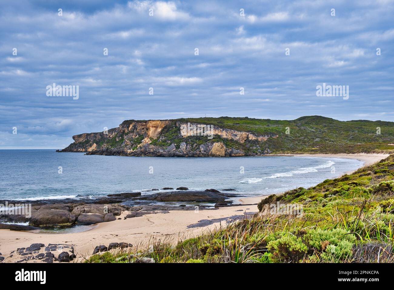 Coastal scenery: bay with deserted beach and limestone cliffs ...