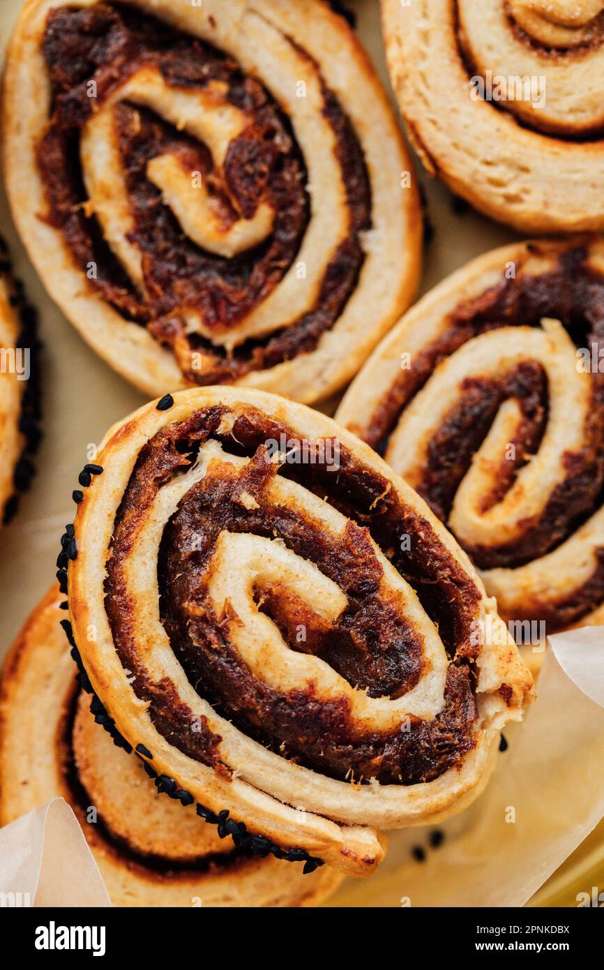 pile of Kleicha, Iraqi date cookies in spiral form with black seeds ...
