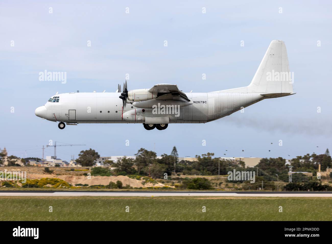 An all white Lockheed L-100-30 Hercules (L-382G) (REG: N2679C) trailing ...