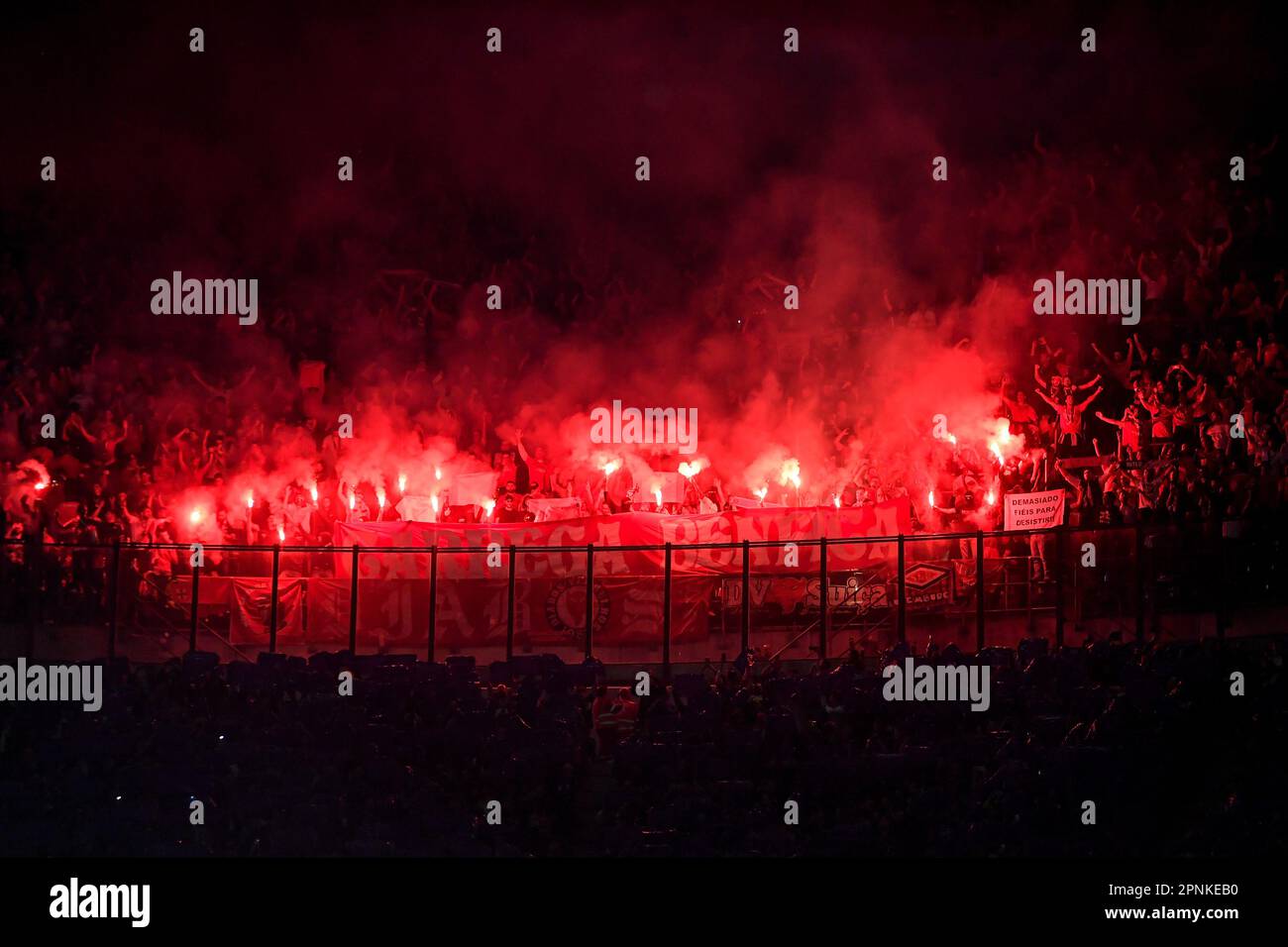 Milan, Italy. 19th Apr, 2023. Benfica fans light flares and smoke bombs ...