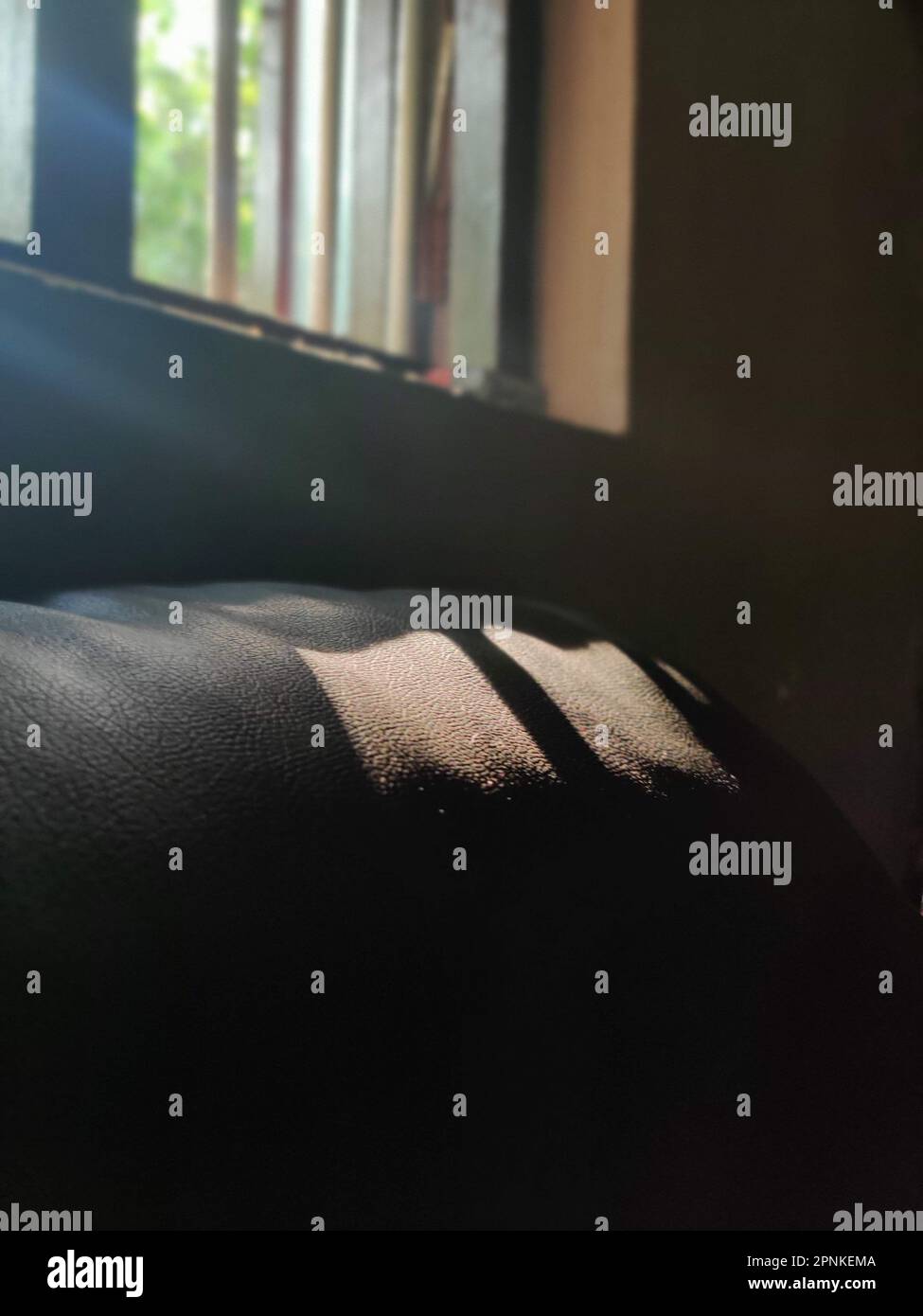 A sunbeam streams through an open window, illuminating a cozy bedroom ...