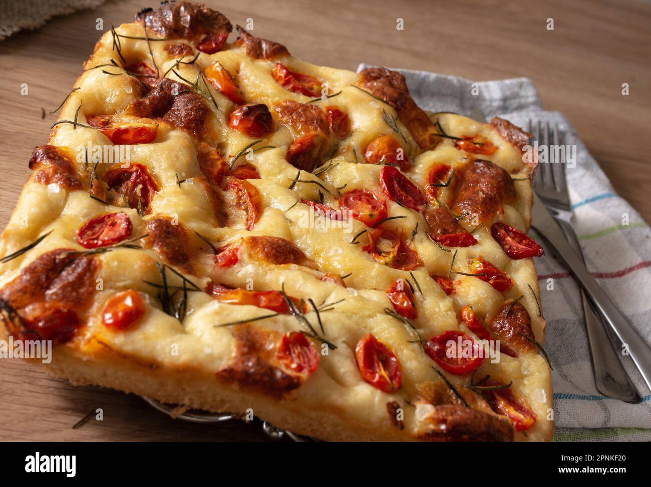 Homemade Italian Pugliese focaccia with rosemary and oil on rustic wood ...