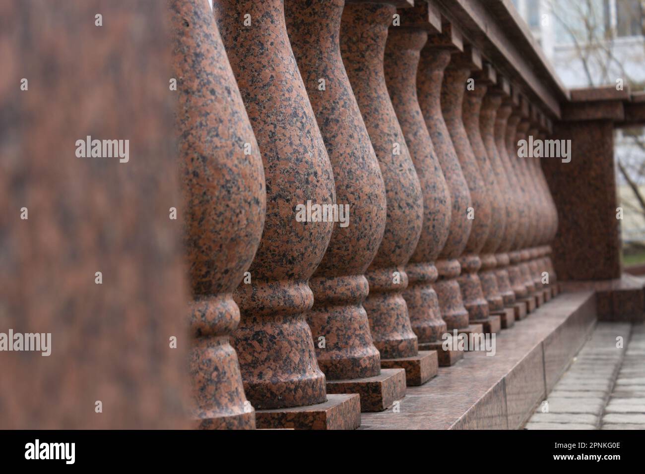 Stone balusters made of pink granite, marble close-up, selective focus ...