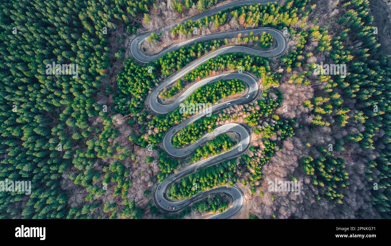 Aerial photography of a winding road in the mountains with serpentines ...