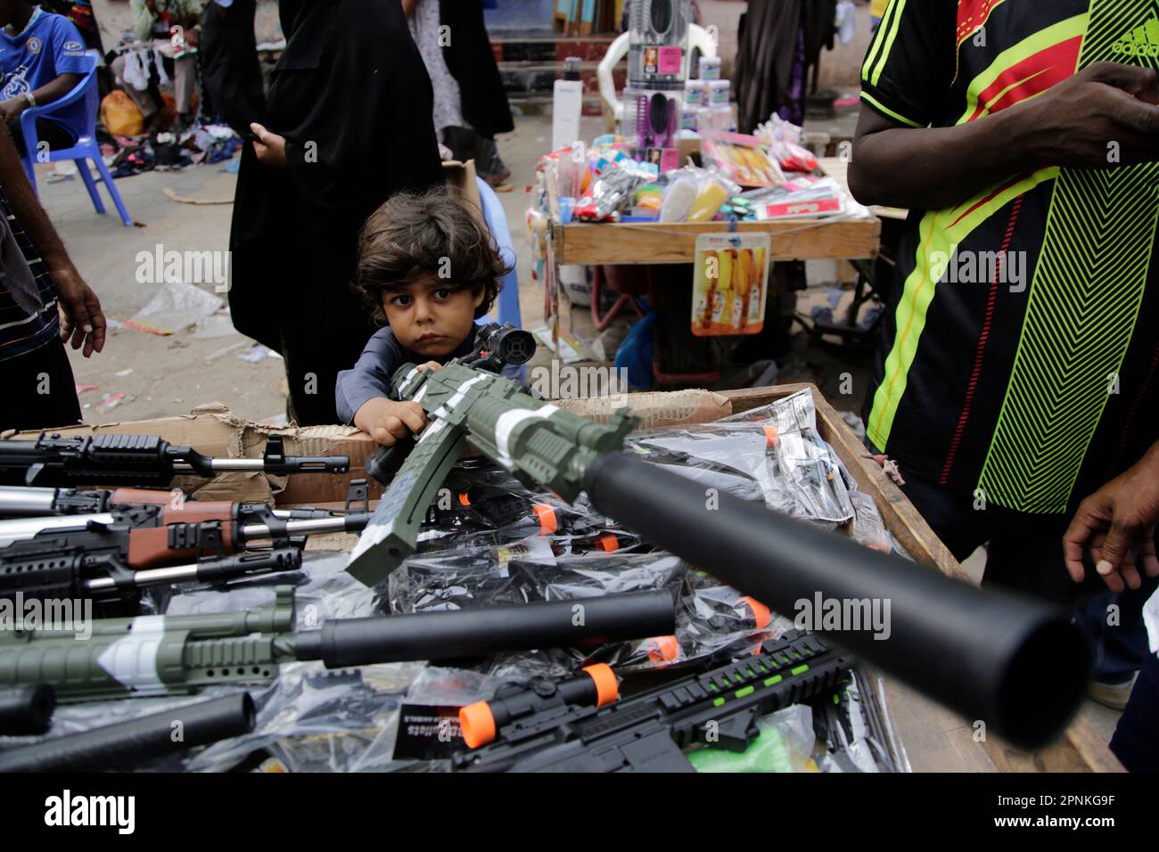 A child plays with a toy gun at a street market in Mogadishu, Somalia ...