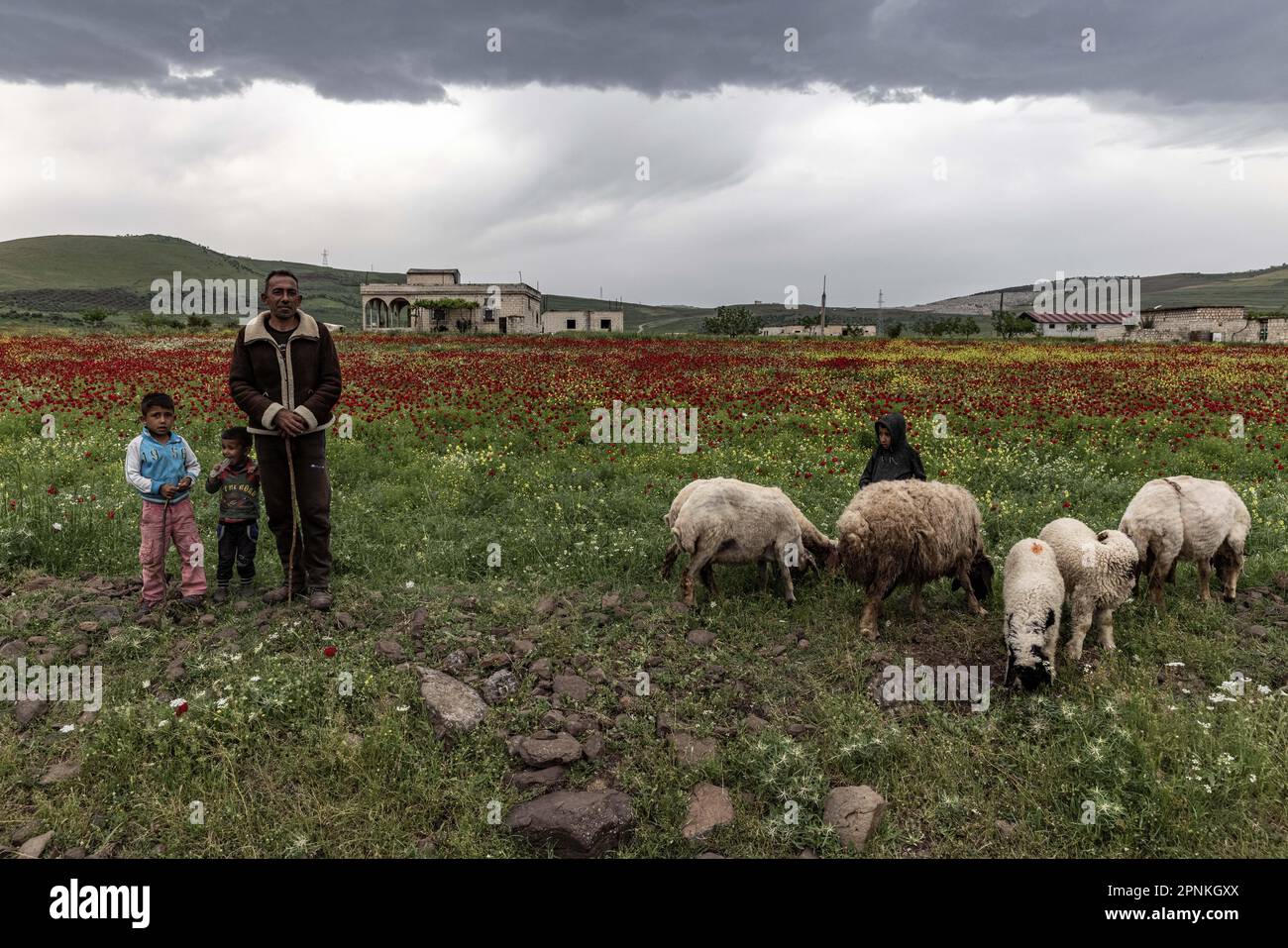 Ein El Hamra, Syria. 19th Apr, 2023. A man with his children are ...