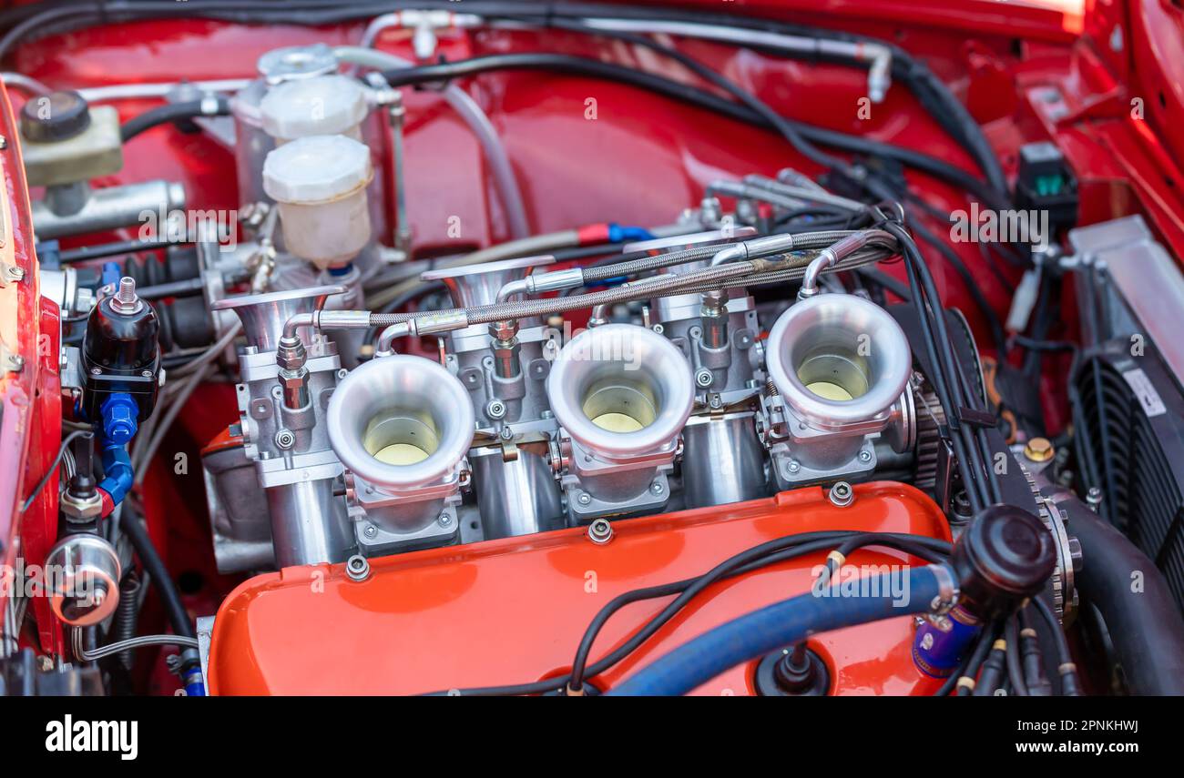close up of sixties racing car engine with red bodywork Stock Photo - Alamy