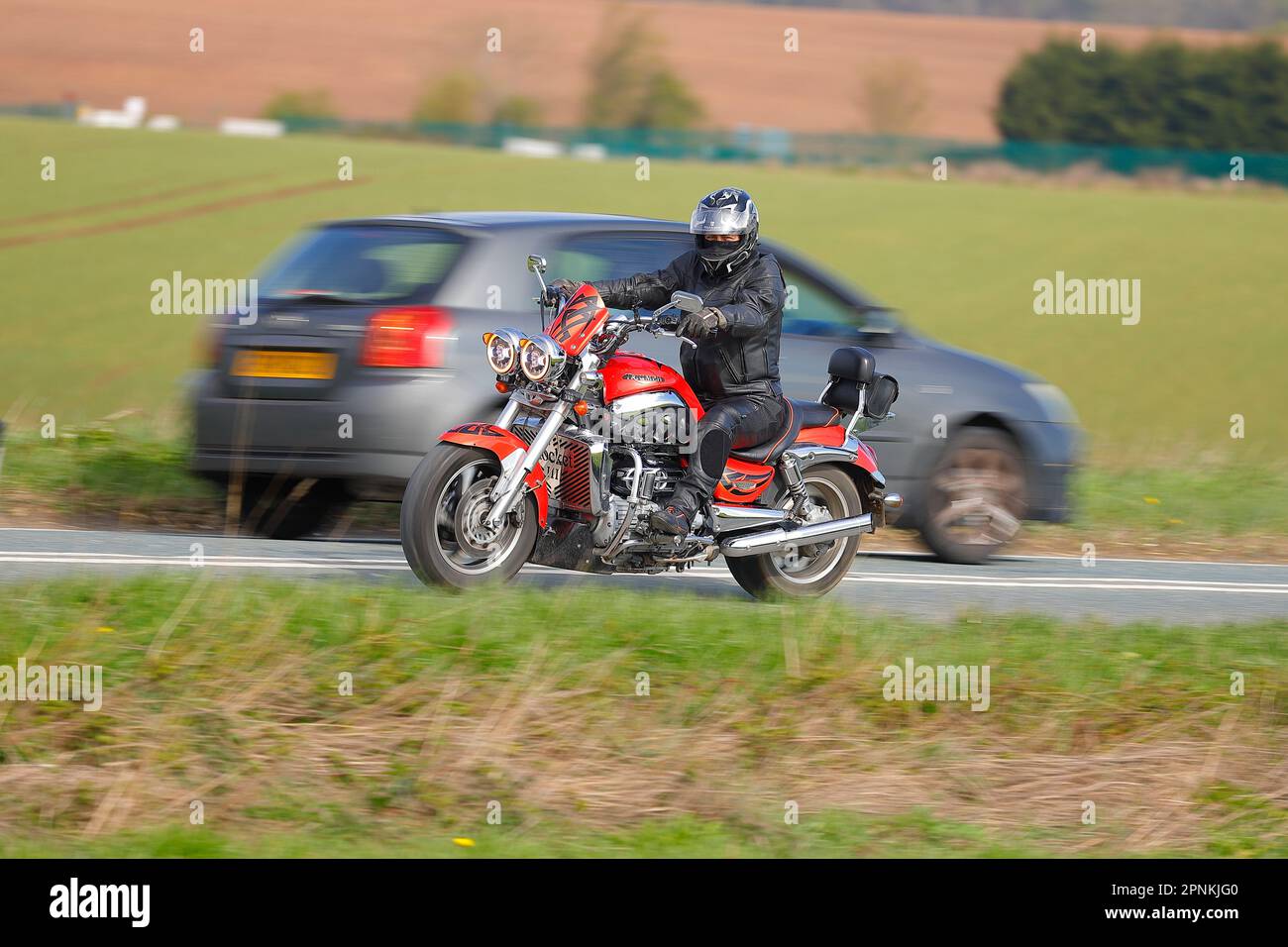 A motorcyclist riding along the B1222 on a Triumph Rocket 3 towards ...