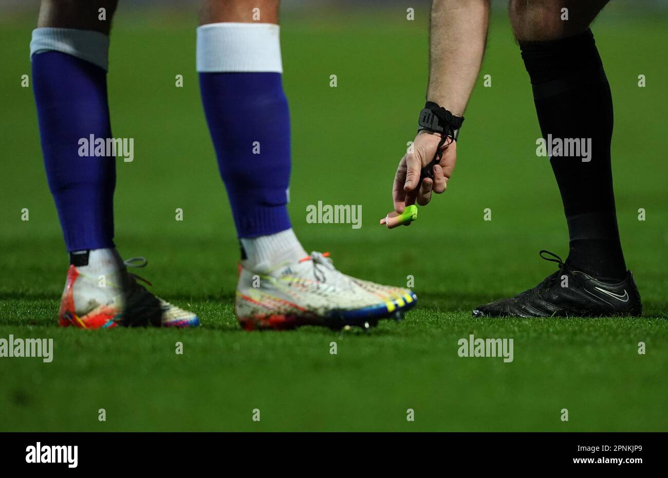 Referee Jeremy Simpson picks up a missile thrown from the crowd during ...