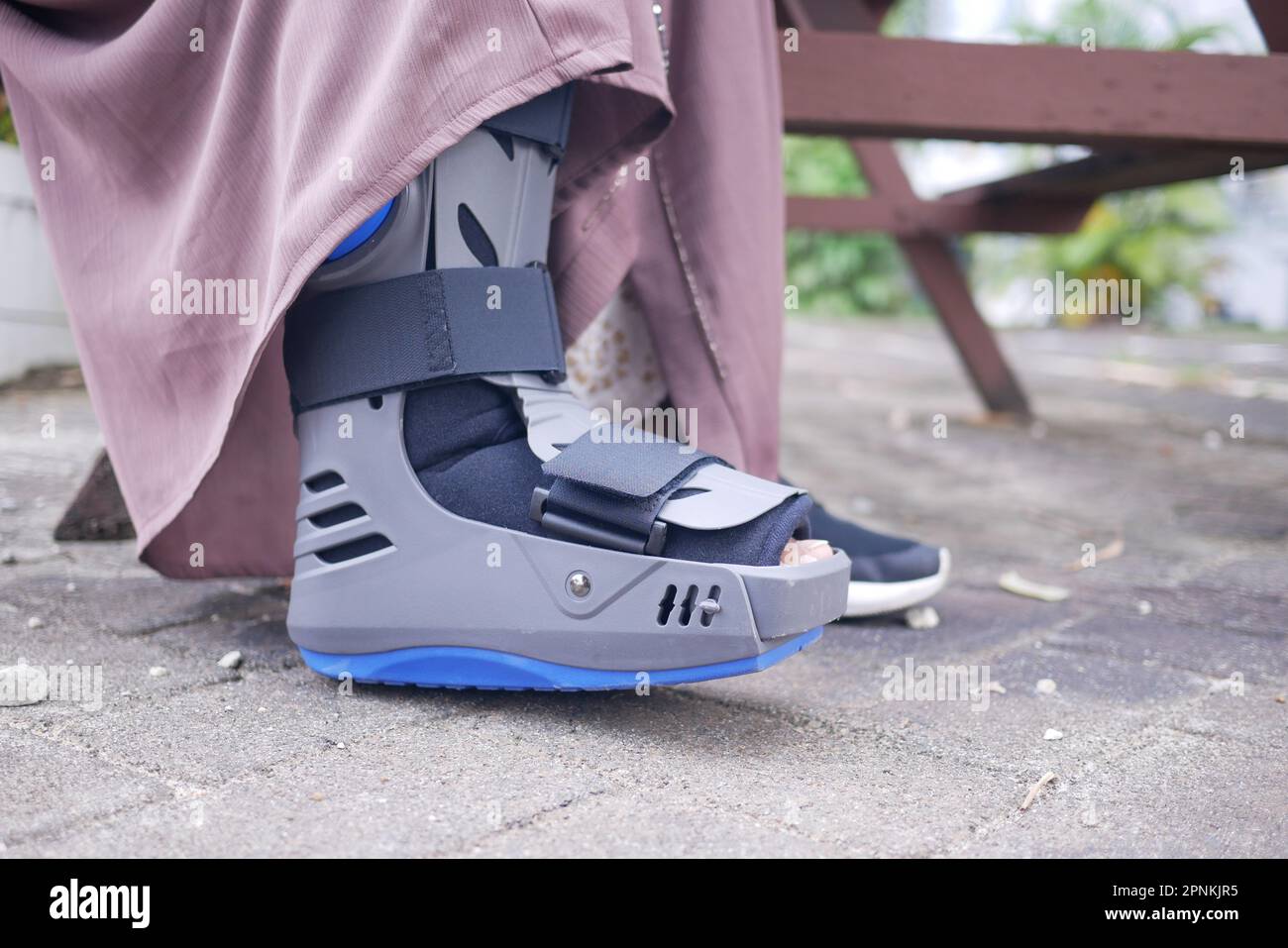 women broken feet with a grey plastic boot ankle brace injury ...