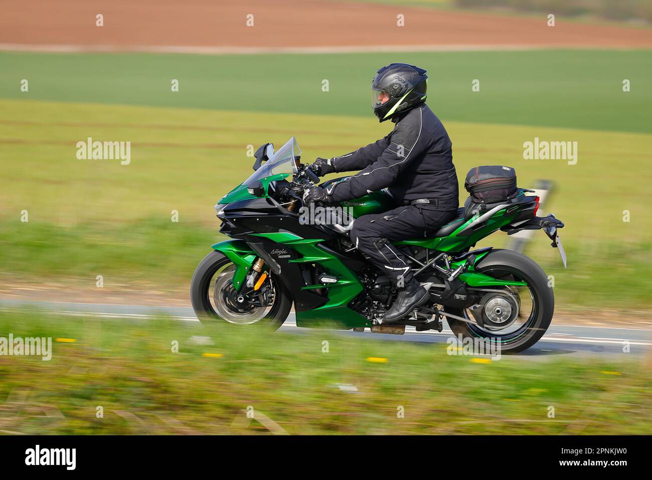A motorcyclist riding a Kawasaki Ninja motorcycle along the B1222 ...