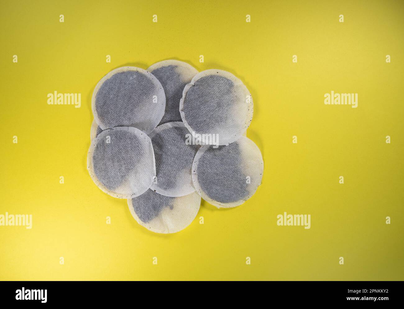small pile of round tea bags isolated on a yellow background Stock ...