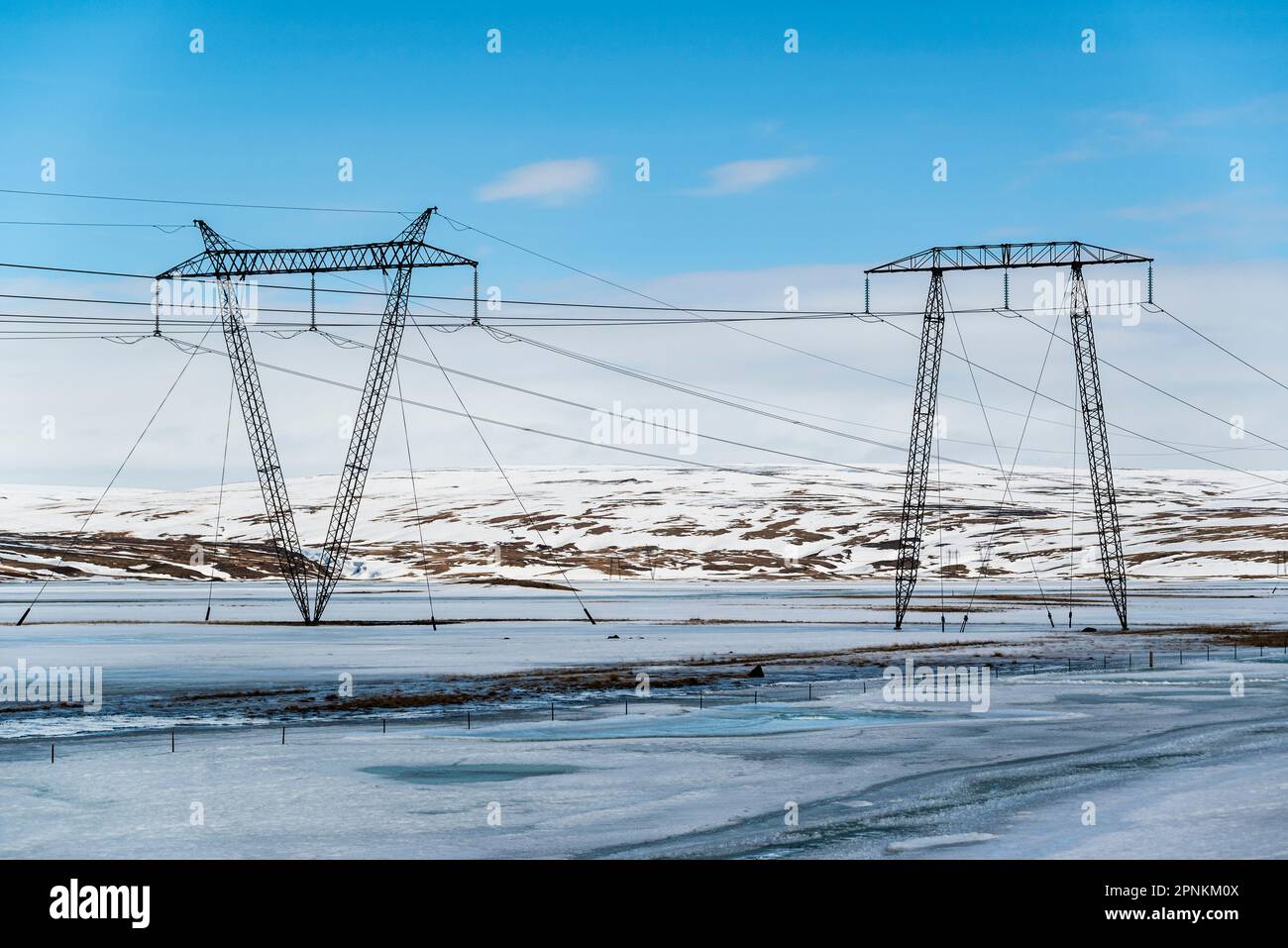 Two of the typical Icelandic transmission towers in a frosty winter ...
