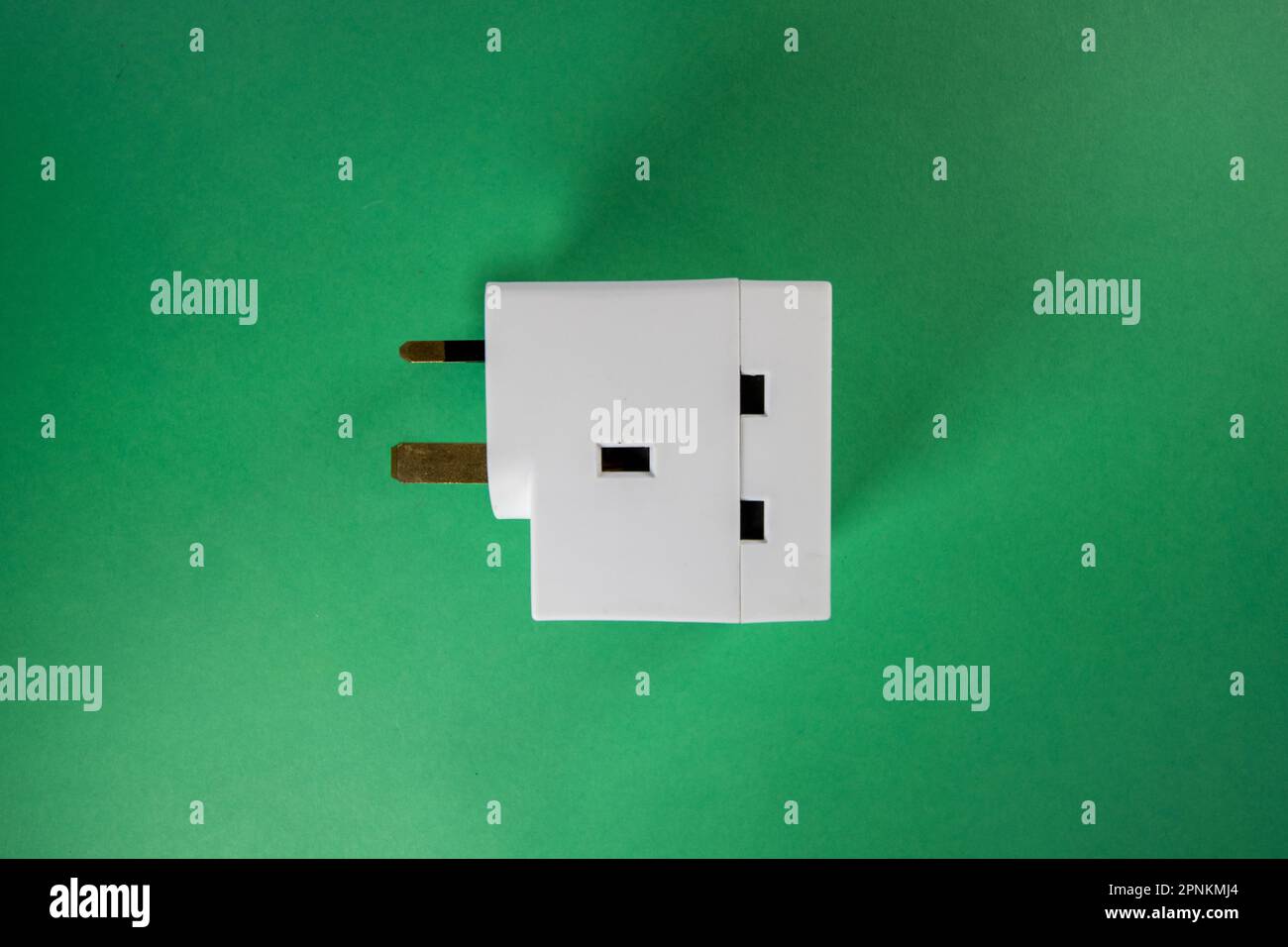 three pin gang plug for multi socket use isolated on a dark green ...