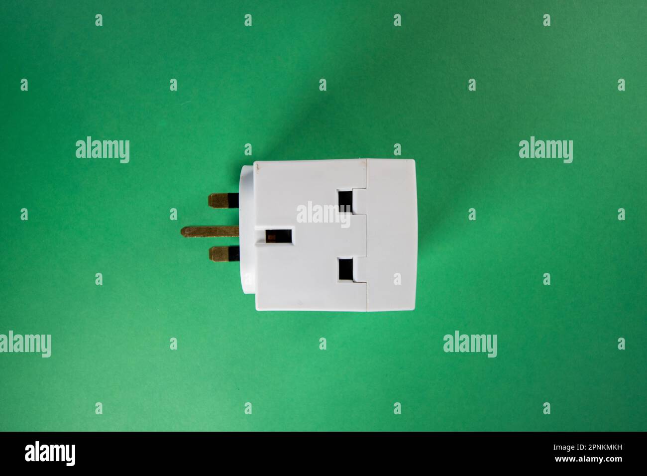 three pin gang plug for multi socket use isolated on a dark green ...
