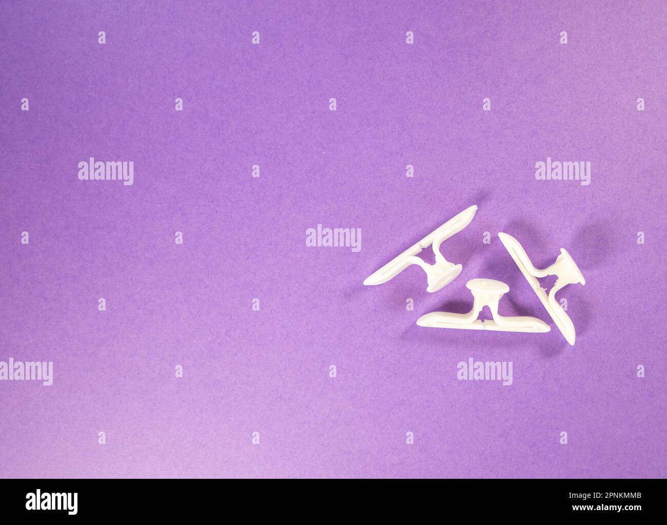 three plastic toggle fixings for plasterboard hollow walls isolated on ...