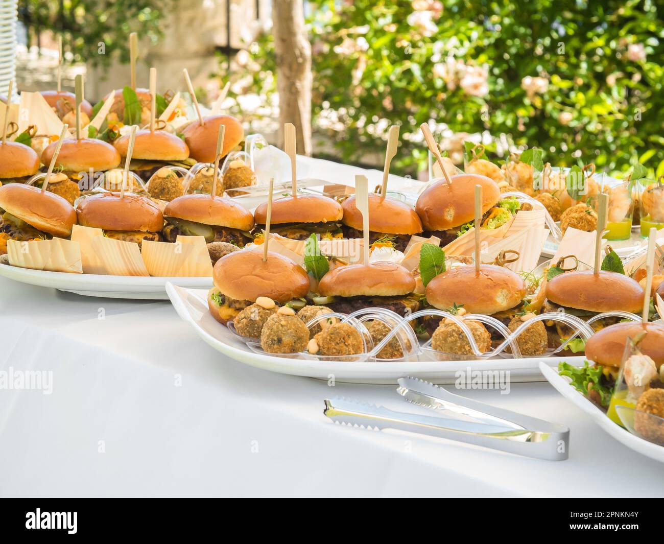 Banquet table with snacks food on plates hamburger party dinner table ...