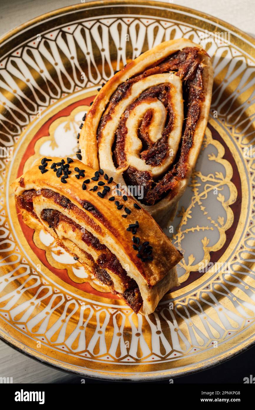 Kleicha, Iraqi date cookies in spiral form with nigella seeds on ornate ...