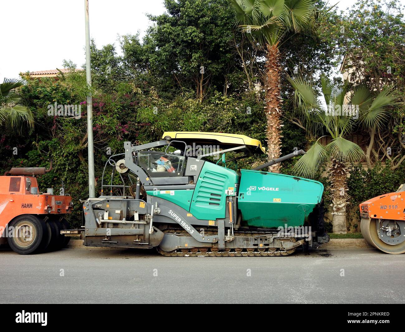 Cairo, Egypt, April 7 2023: Asphalt paver trucks and compactors, A ...