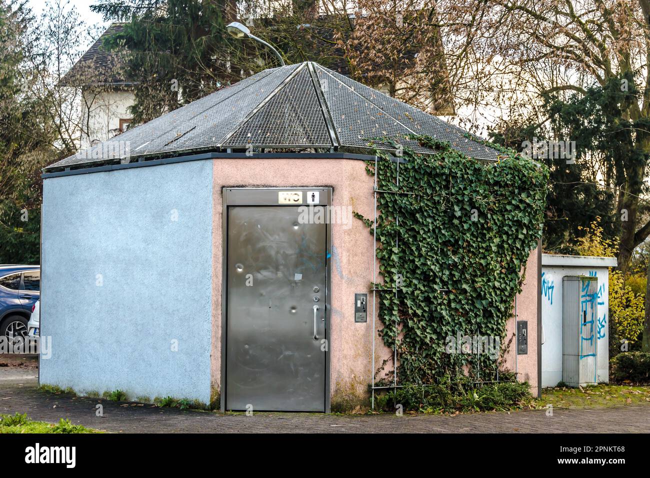 Public toilet in a city with graffiti and metal door Stock Photo - Alamy