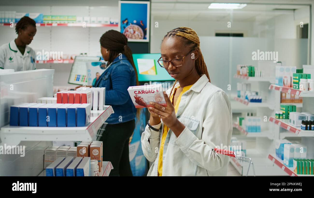 Black woman reading leaflet hi-res stock photography and images - Alamy