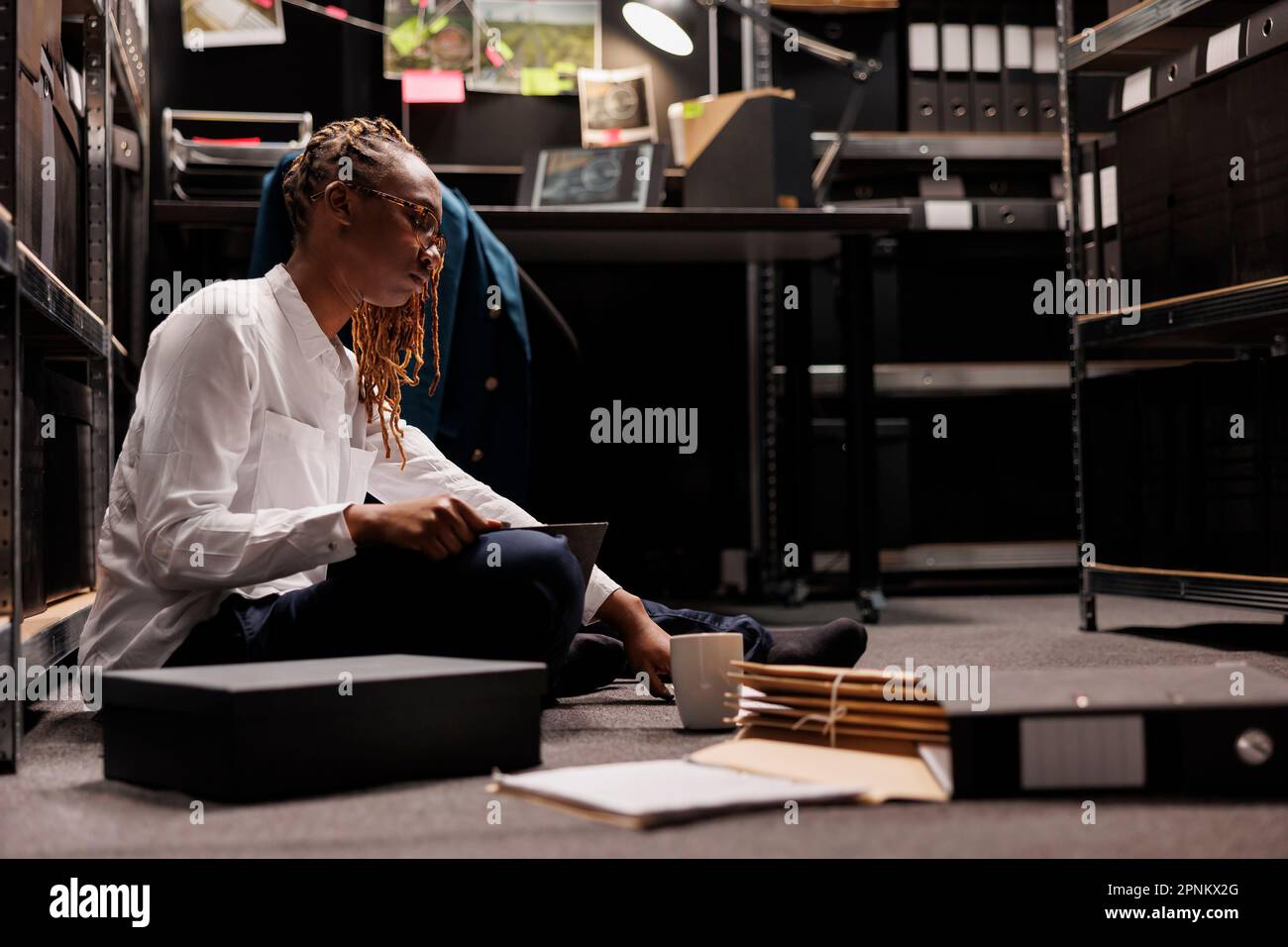 Woman investigator solving crime while sitting on floor in police ...