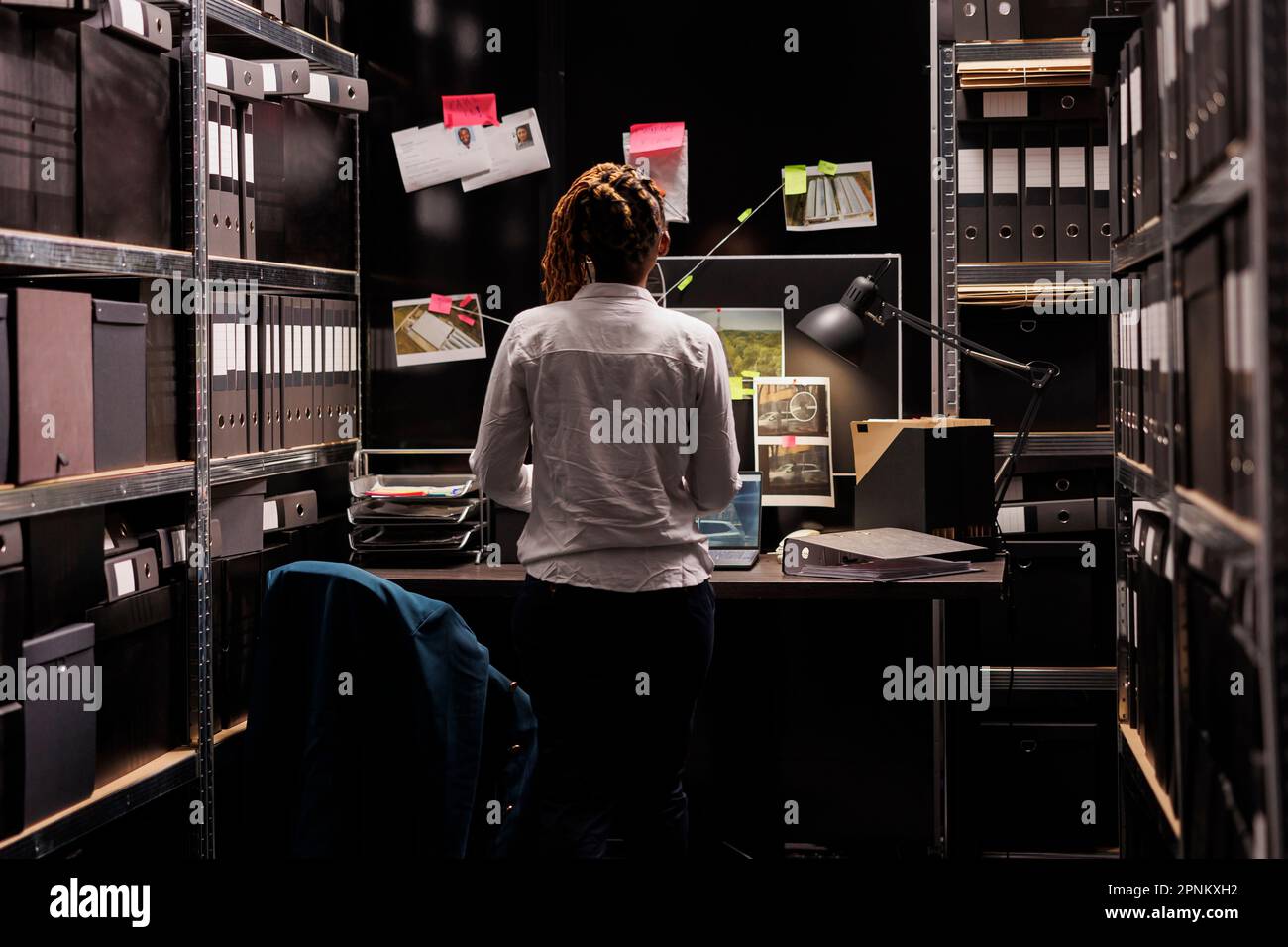 Woman Investigator Looking At Detective Board Analyzing Evidence And