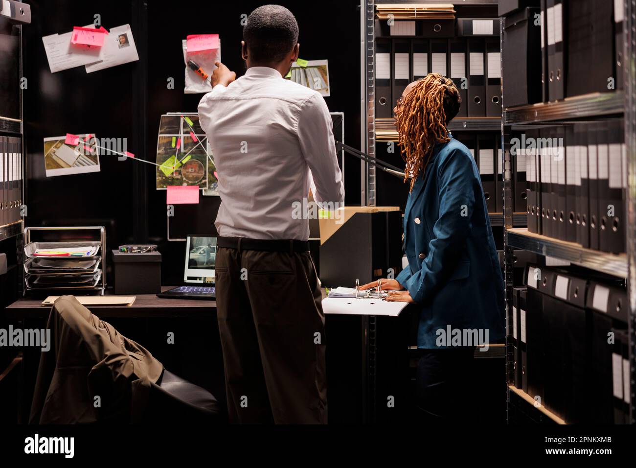 African american man and woman investigators studying evidence ...